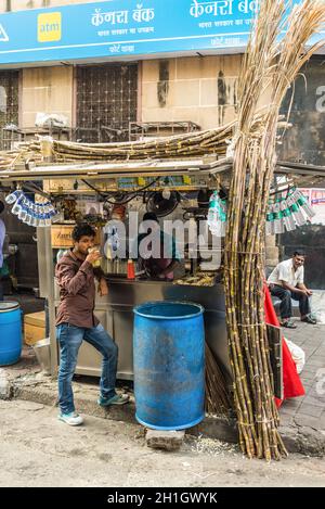 traditional sugarcane juice extraction machine crushing fresh cane at ...