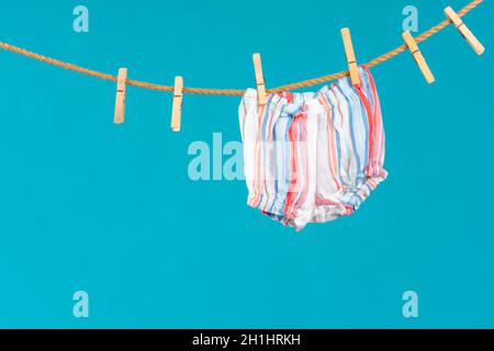 Clothesline with pinned baby clothes close up Stock Photo - Alamy