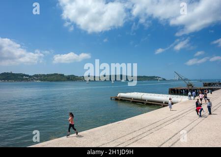 Lisbon, Portugal - May 27, 2018: People walking along the Tagus River ...