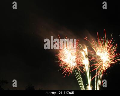 A closeup shot of beautiful fireworks during dark night Stock Photo - Alamy