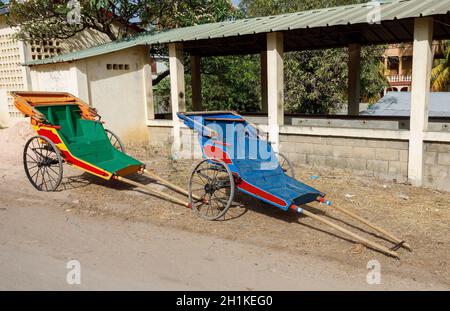 Pulled rickshaw in street of north Madagascar. Human-powered rickshaws ...