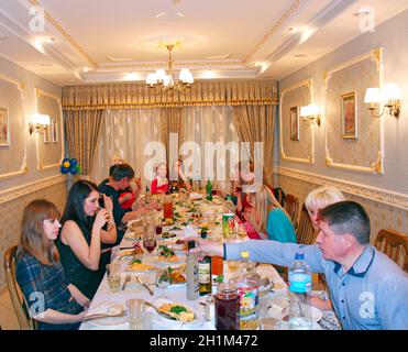 Happy girl enjoying delicious salad and red wine in stylish modern ...