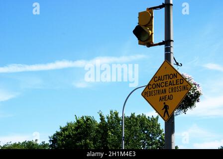 yellow road sign "hidden intersection Stock Photo - Alamy