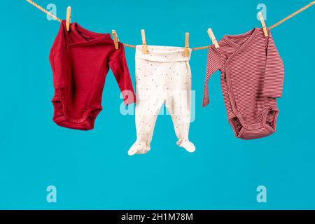 Clothesline with pinned baby clothes close up Stock Photo - Alamy