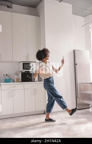 Smiling Afro Lady In Wireless Headphones Gesturing Victory Sign, Studio ...
