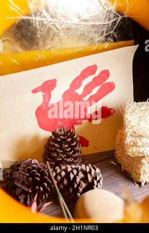 Red hand turkey on vanilla construction paper with orange berries, fall ...