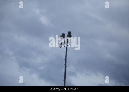 Field lights against a dark, dreary, grey sky Stock Photo - Alamy