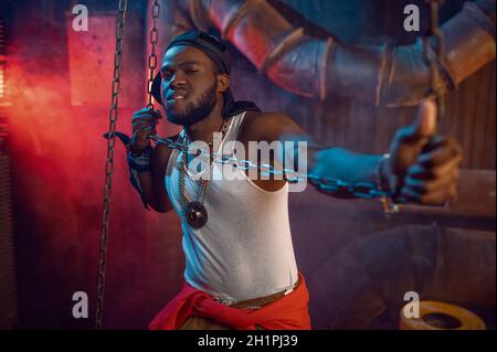 Young stylish rapper poses in illuminated cube. Hip-hop performer, rap ...