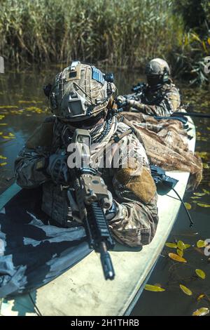 Special forces operators in a military kayak Stock Photo - Alamy