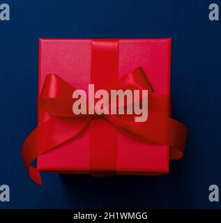 Christmas gift box tied with blue ribbon with bow with green Christmas ...