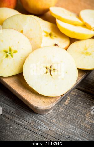 Freshly harvested red apples with leaves in wooden crate on rustic ...