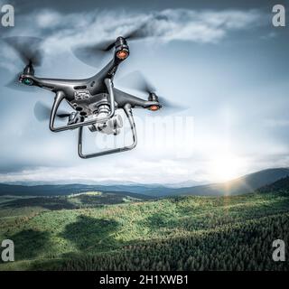 Dark drone flying above mountains Stock Photo - Alamy