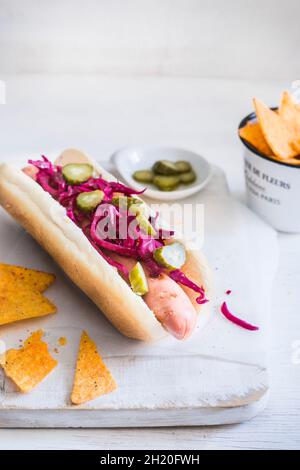 A hot dog with pickled red cabbage and gherkins Stock Photo - Alamy
