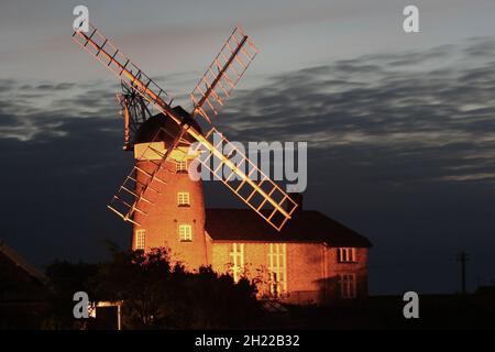 A red brick windmill illuminated at night with cloud Stock Photo - Alamy