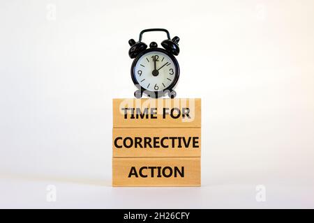 Corrective action symbol. Wooden blocks with words 'Corrective action ...