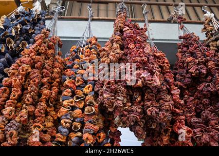 dried vegetables, spices hung up on strings for cooking being sold on ...