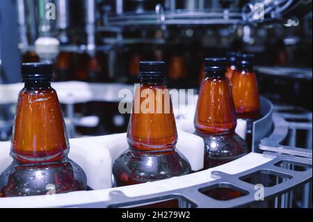 Large filling machine, the process of filling plastic bottles with ...