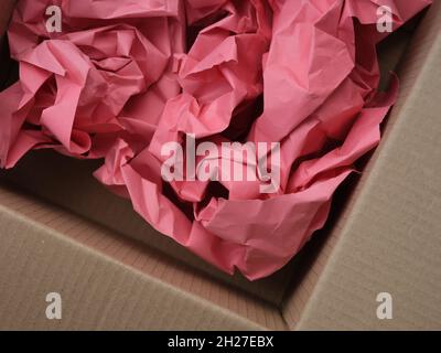 Crumpled paper in a cardboard box. Close up Stock Photo - Alamy