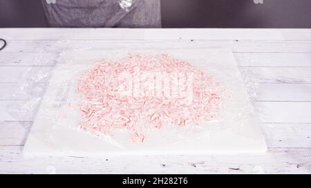 Step by step. Breaking candy cane candies into small pieces Stock Photo ...