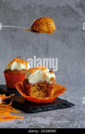 a bitten carrot cake next to the whole Stock Photo - Alamy