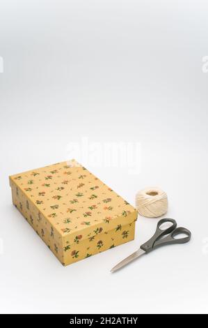 decorated paperboard box with lid decorative yarn and scissors on a ...