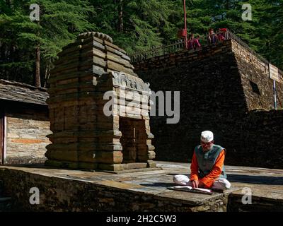 Priest reading sacred book in front of temple Stock Photo - Alamy