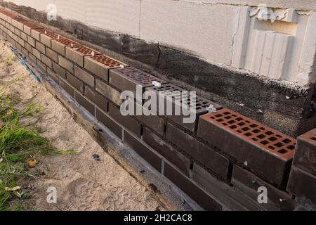 brick plinth around the house Stock Photo - Alamy