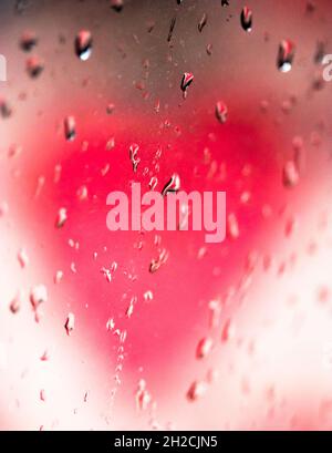 Blurry red heart shape window with raindrops. Valentine's Day, unhappy love Stock Photo - Alamy