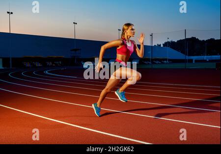 Runner sprinting towards success on run path running athletic track ...