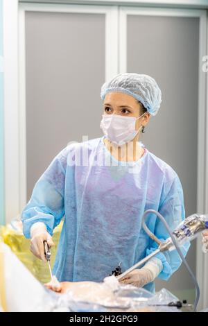 Surgeon performs minimally invasive laparoscopic abdominal surgery, as ...