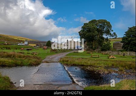 A rural farm, ‘Ravenseat’ beside the flowing Whitsundale Beck in ...