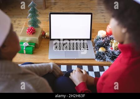 Mother and daughter making laptop christmas video call with happy ...