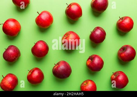 Many red apples on colored background, top view. Autumn pattern with ...