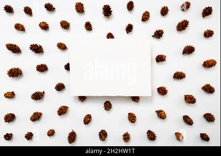 blank Christmas card ,pine cones and pencil on wooden backgroun Stock ...