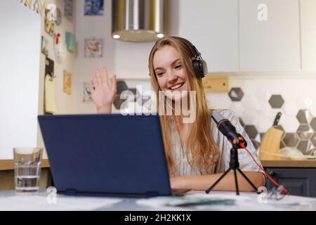 Happy girl interpreter in headset write notes study on laptop Stock ...