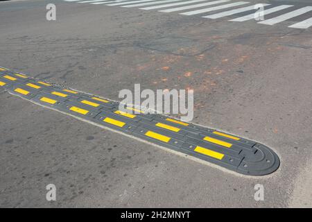 Speed bump on the road at the crosswalk Stock Photo - Alamy