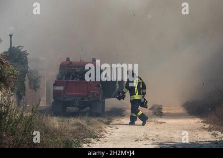 PORTO CESAREO, ITALY - Jun 08, 2017: The Firefighters at work to put ...