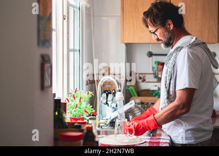 A bearded man cleaning the house and looking involved Stock Photo - Alamy