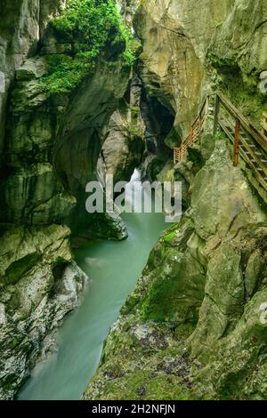 A vertical shot of a rock formation on a mountain against a blue sky ...