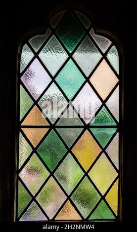 Leaded coloured glass window in garden shed Stock Photo - Alamy