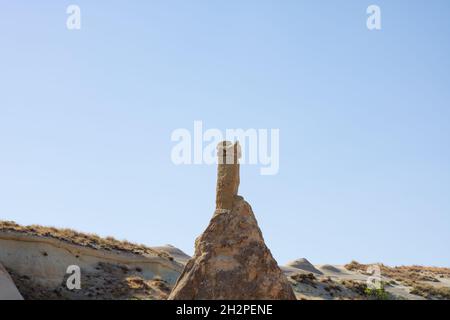 A fairy chimneys or peri bacasi on clear sky background in Cappadocia ...