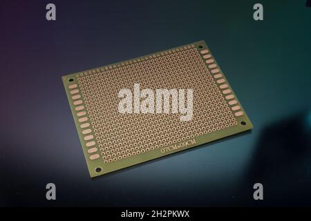 empty clear universal prototype printed circuit board on the background ...