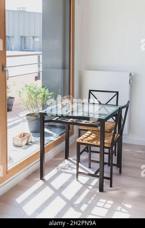 A vertical shot of a big house with a terrace and garden with blooming ...