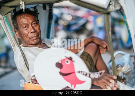 Rickshaw driver taking a break in Hua Hin. This is an old fishing ...