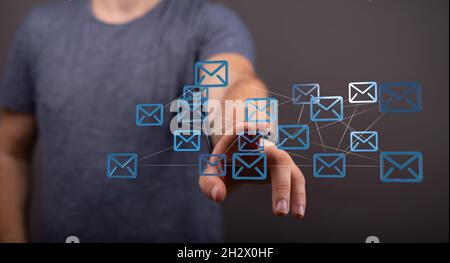 A male's hand pointing to illustrated email inbox electronic ...