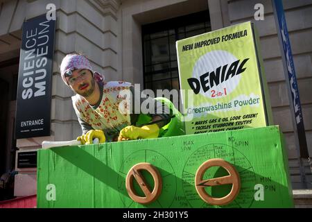 Extinction Rebellion protester dressed as a giant carrying a sign that ...