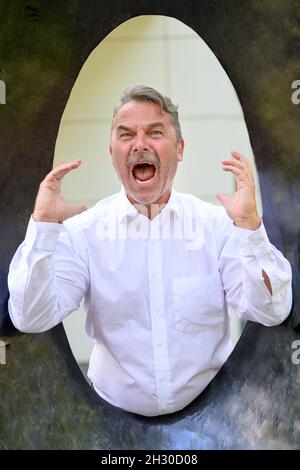 Vintage style photo in oval frame of a man middle-age screaming and ...