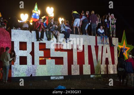 Festival goers climb the Bestival sign on Day 4 of Bestival 2013, Robin ...