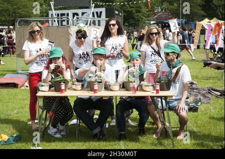 Festival goers compete in a cucumber eating competition on day one of ...