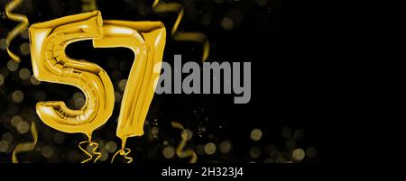 Gold foil balloon number number 57 on a background of blue velvet ...